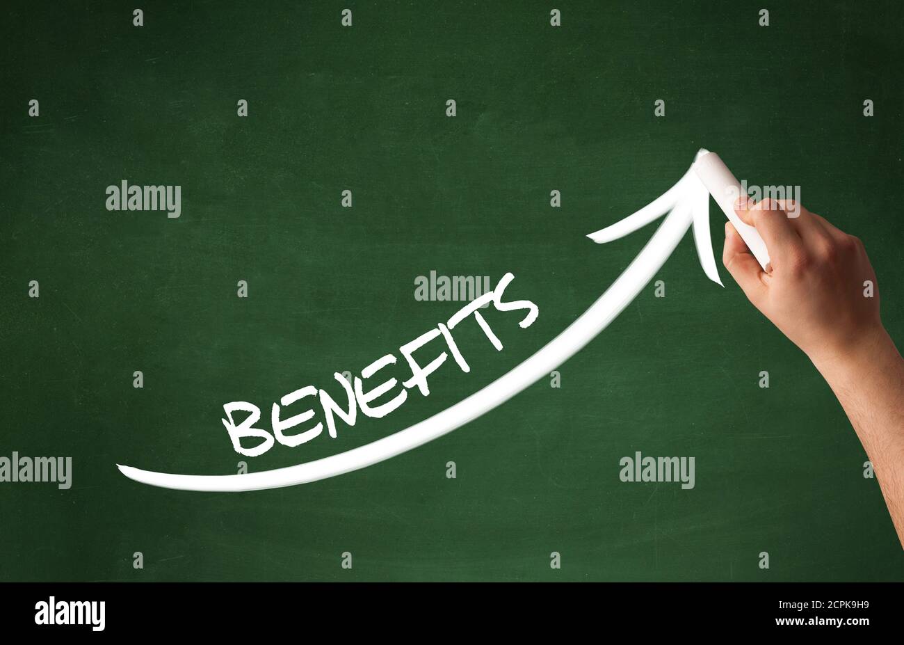 Hand drawing BENEFITS inscription with white chalk on blackboard ...