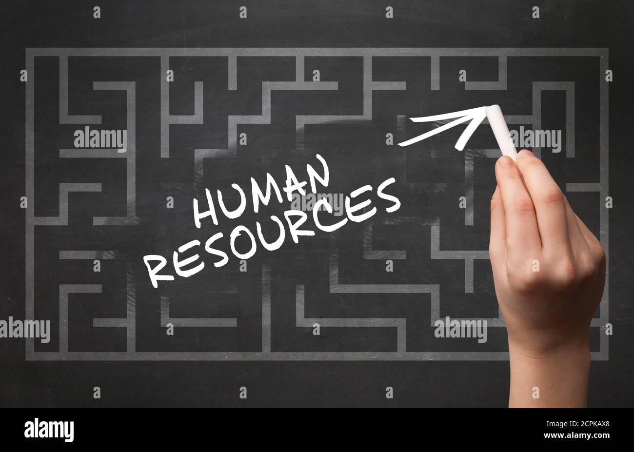 Hand drawing HUMAN RESOURCES inscription with white chalk on blackboard ...