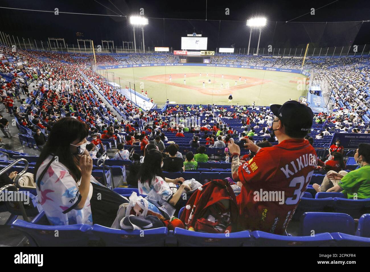 Fans watch a baseball game at Jingu Stadium in Tokyo on Sept. 19, 2020 ...