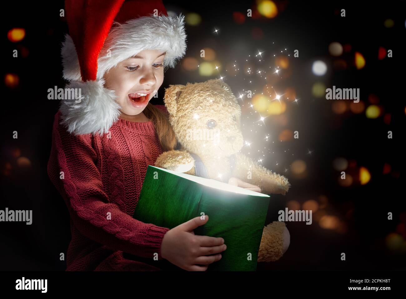 Cute little girl opening a magic gift box Stock Photo - Alamy