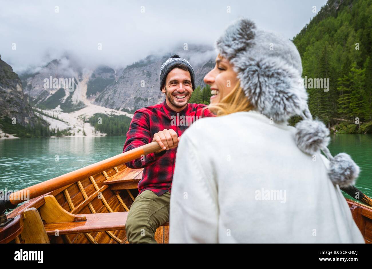 Beautiful couple of young adults visiting an alpine lake at Braies ...