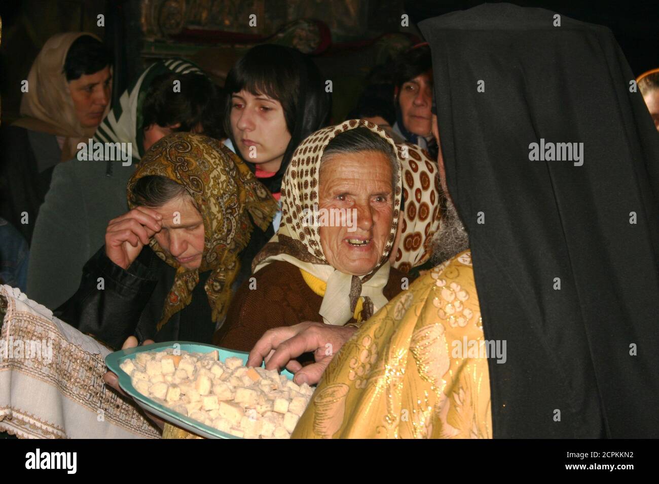 Orthodox Christian believers in Romania being given the Holy Eucharist ...
