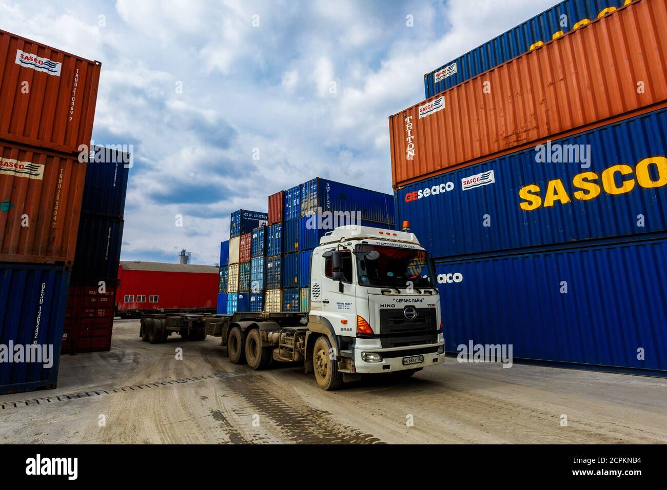 Container terminal. a lorry with a container going among even rows of ...