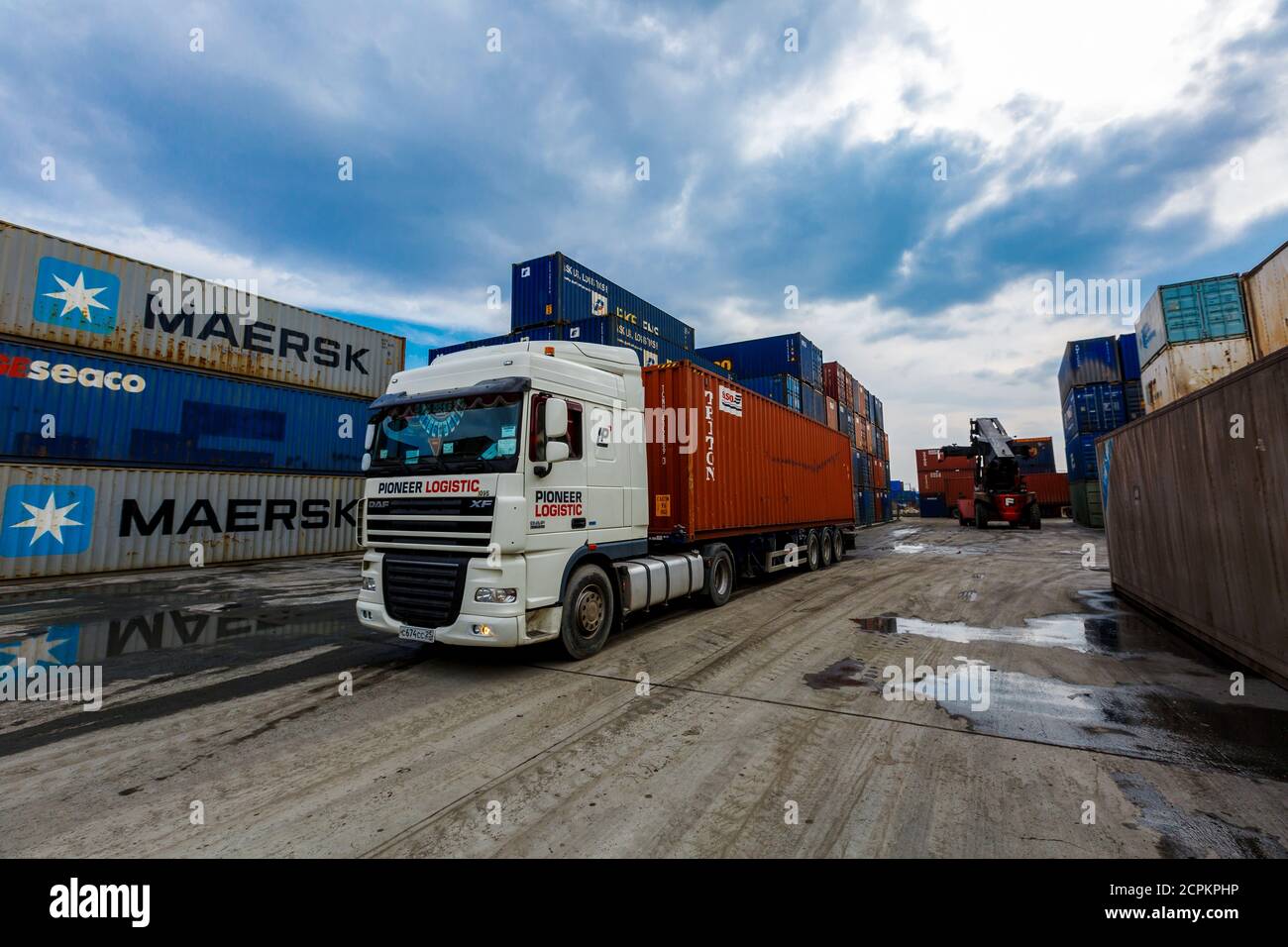 Container terminal. a lorry with a container going among even rows of ...