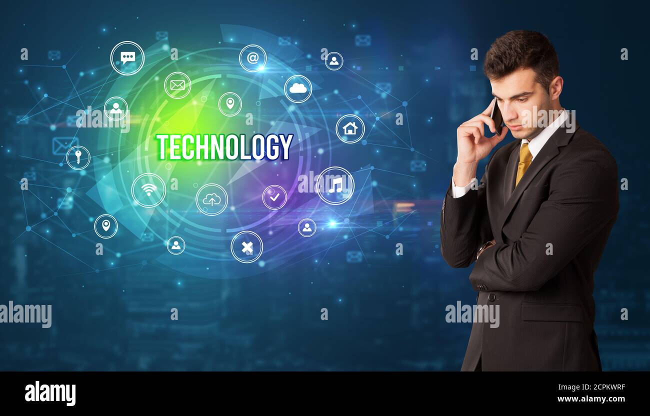 Businessman thinking in front of technology related icons and ...