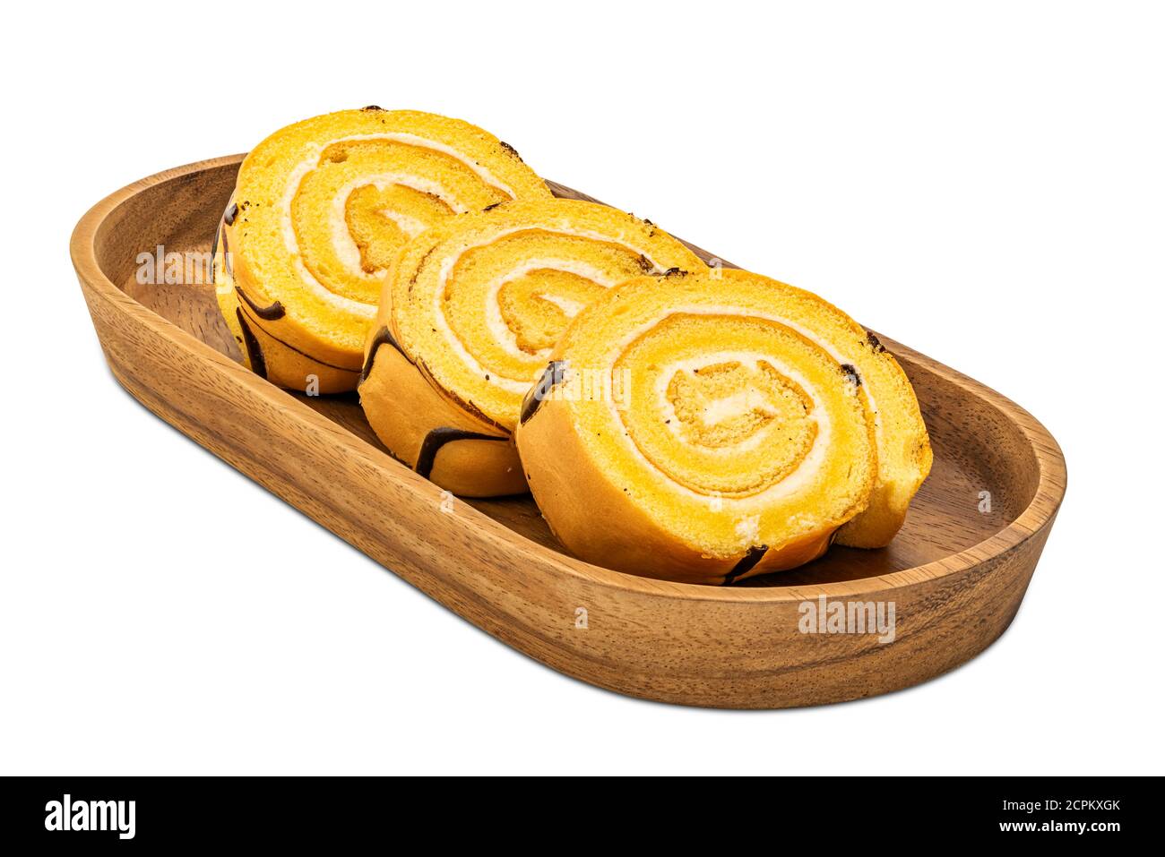 Sliced cake roll in a wooden tray isolated on white background with ...