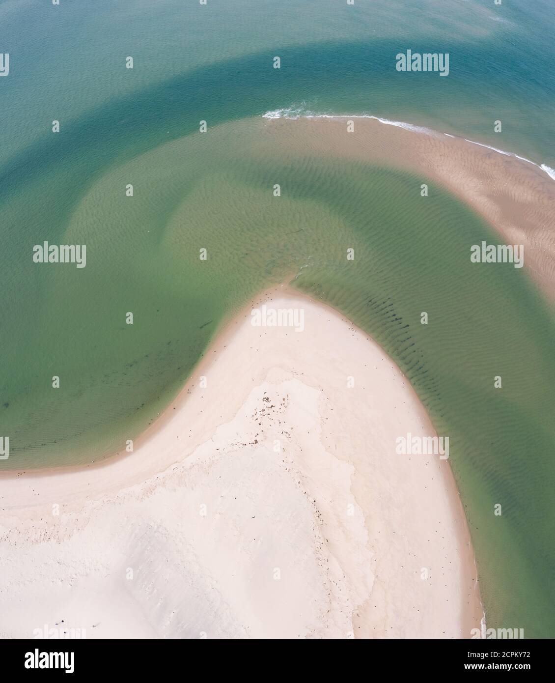 The cold water of the Atlantic Ocean washes onto a beautiful sandy ...