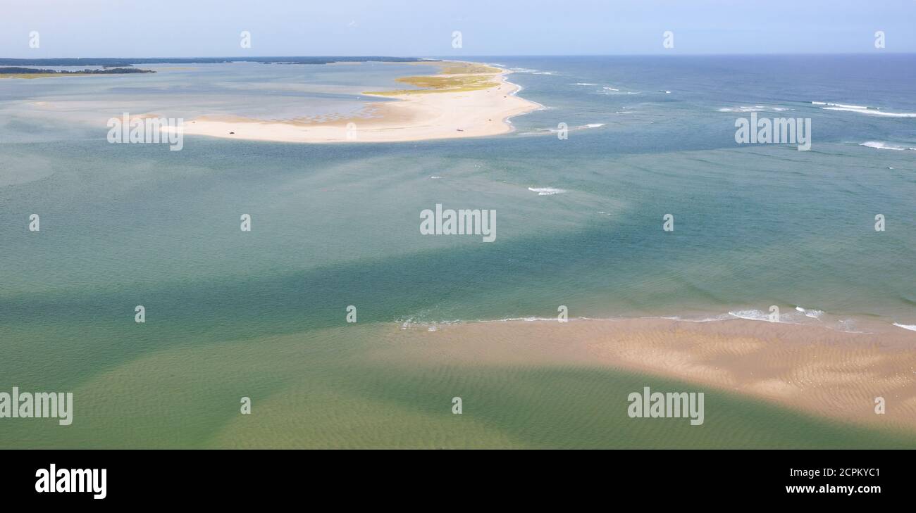 The cold water of the Atlantic Ocean washes onto a beautiful sandy ...
