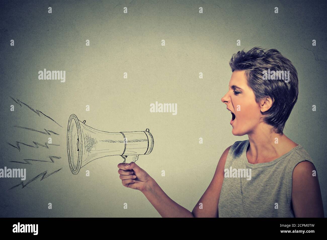 Side profile angry young woman screaming with megaphone isolated on ...