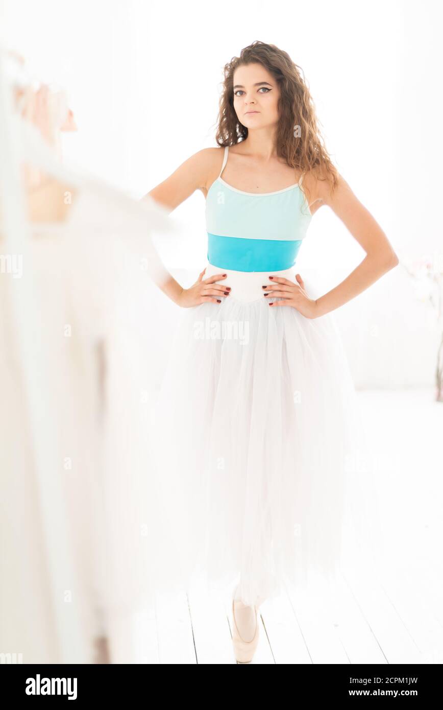 Young beautiful girl ballerina with curly hair Stock Photo - Alamy