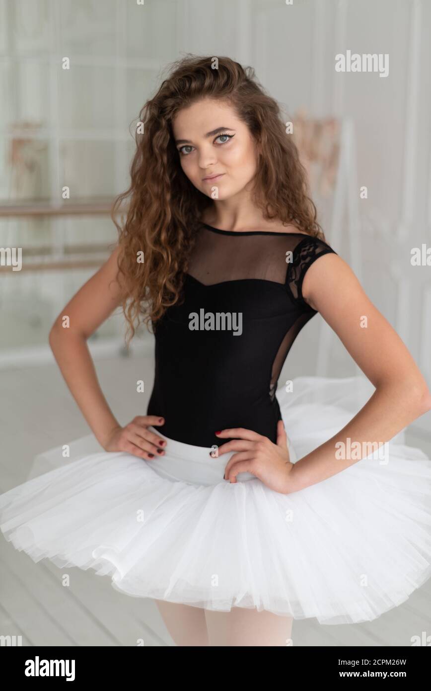Young beautiful girl ballerina with curly hair Stock Photo - Alamy