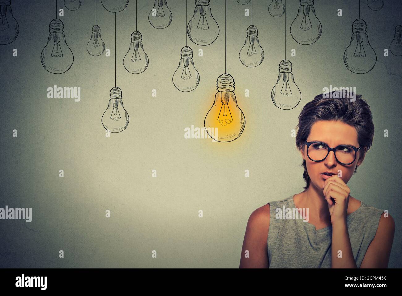young worried woman with glasses thinking hard looking for right ...