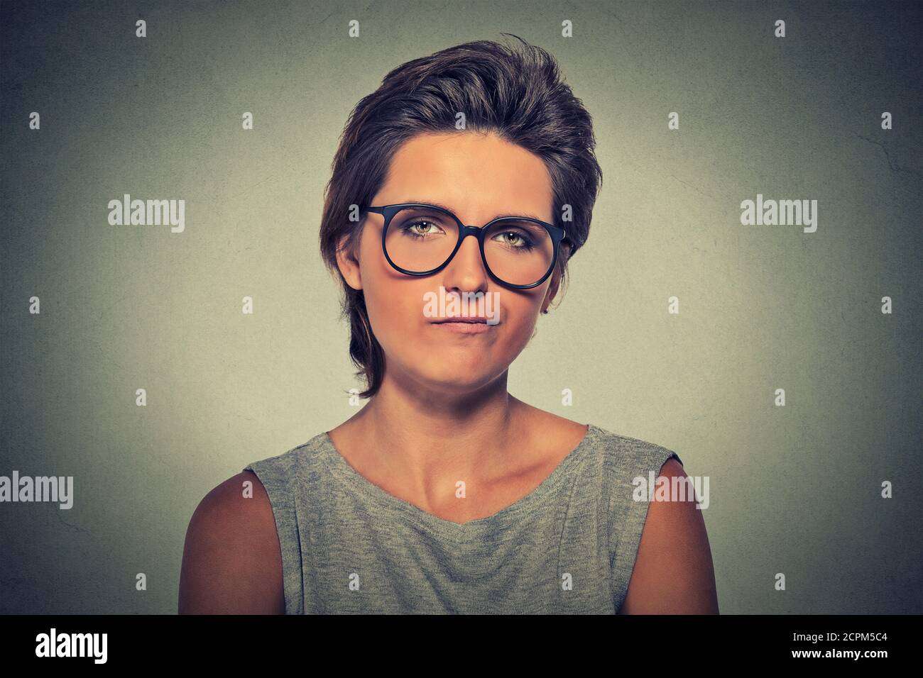 Skeptic. Doubtful upset angry woman in glasses looking at you camera ...