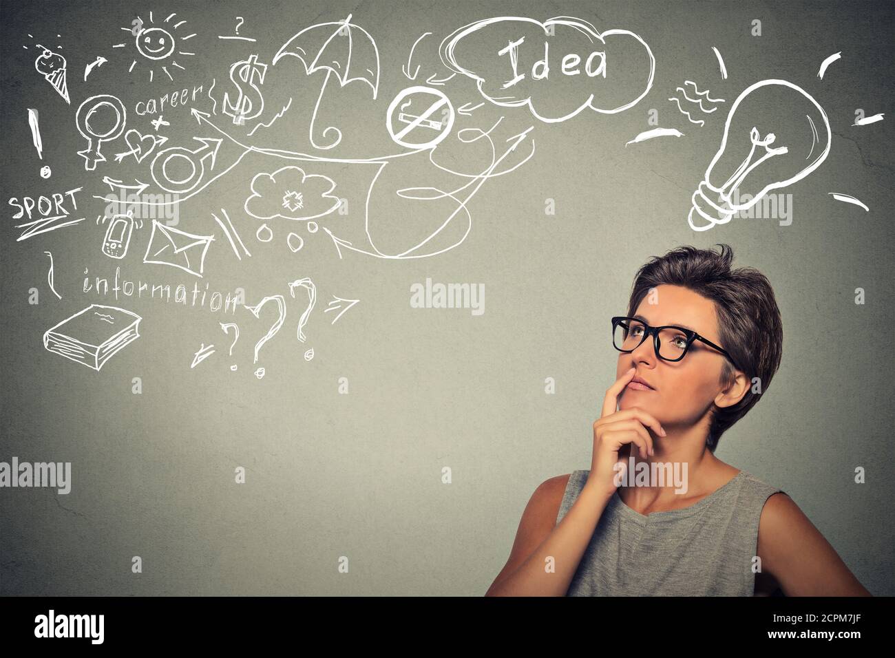 Portrait young woman thinking dreaming has many ideas looking up ...