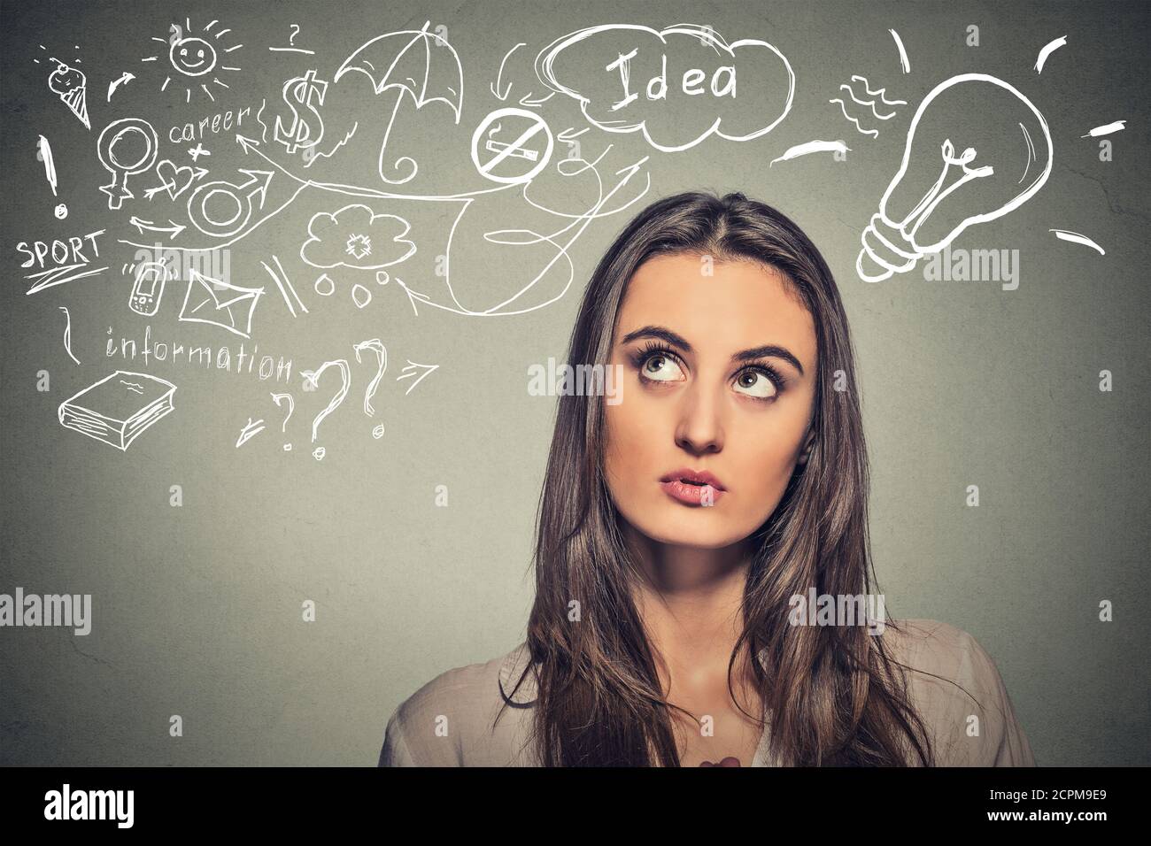 Portrait young woman thinking dreaming has many ideas looking up ...