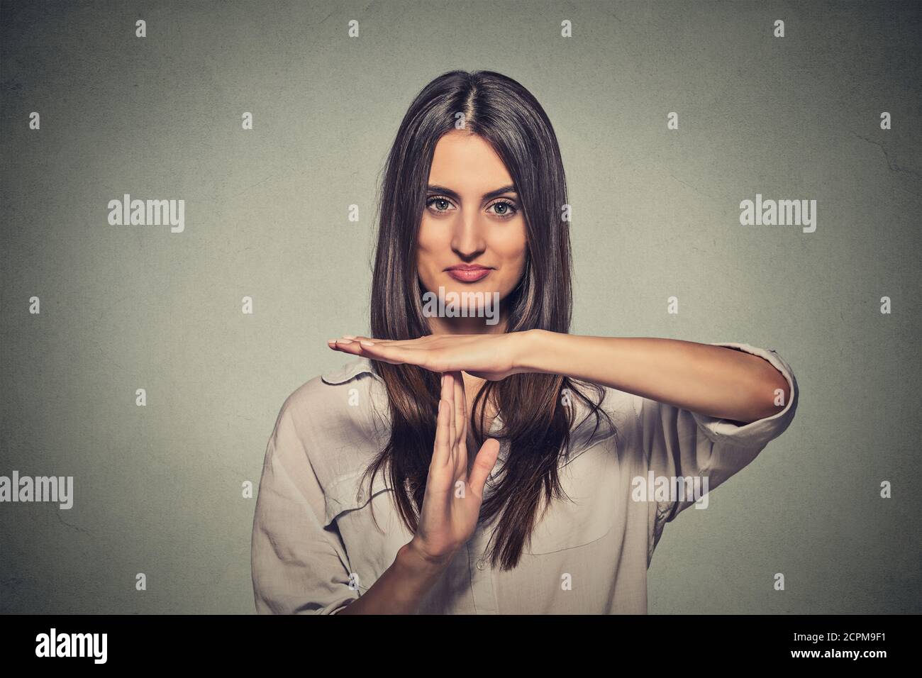 Closeup portrait, young, happy, smiling woman showing time out gesture ...