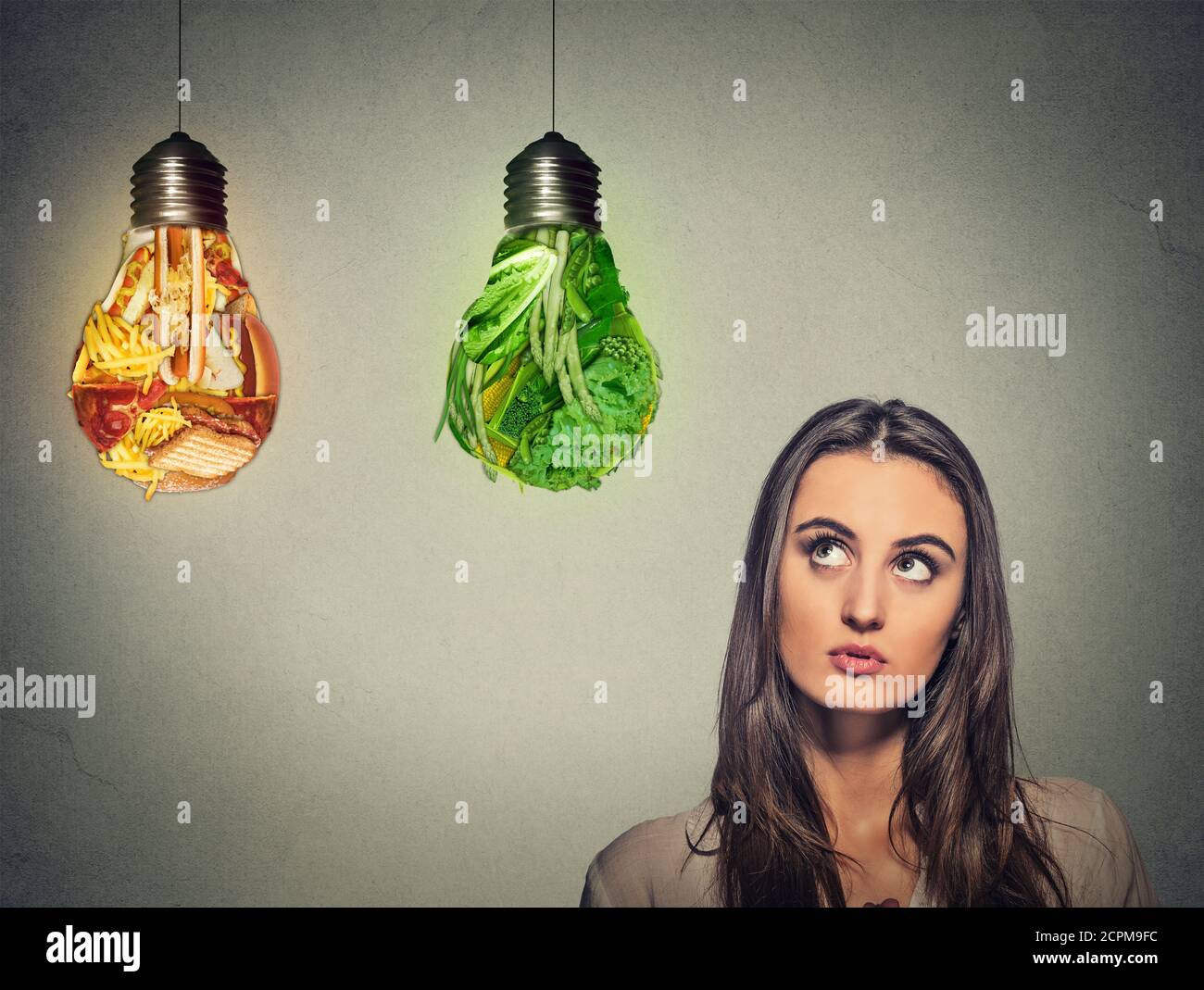Portrait beautiful woman thinking looking up at junk food and green ...