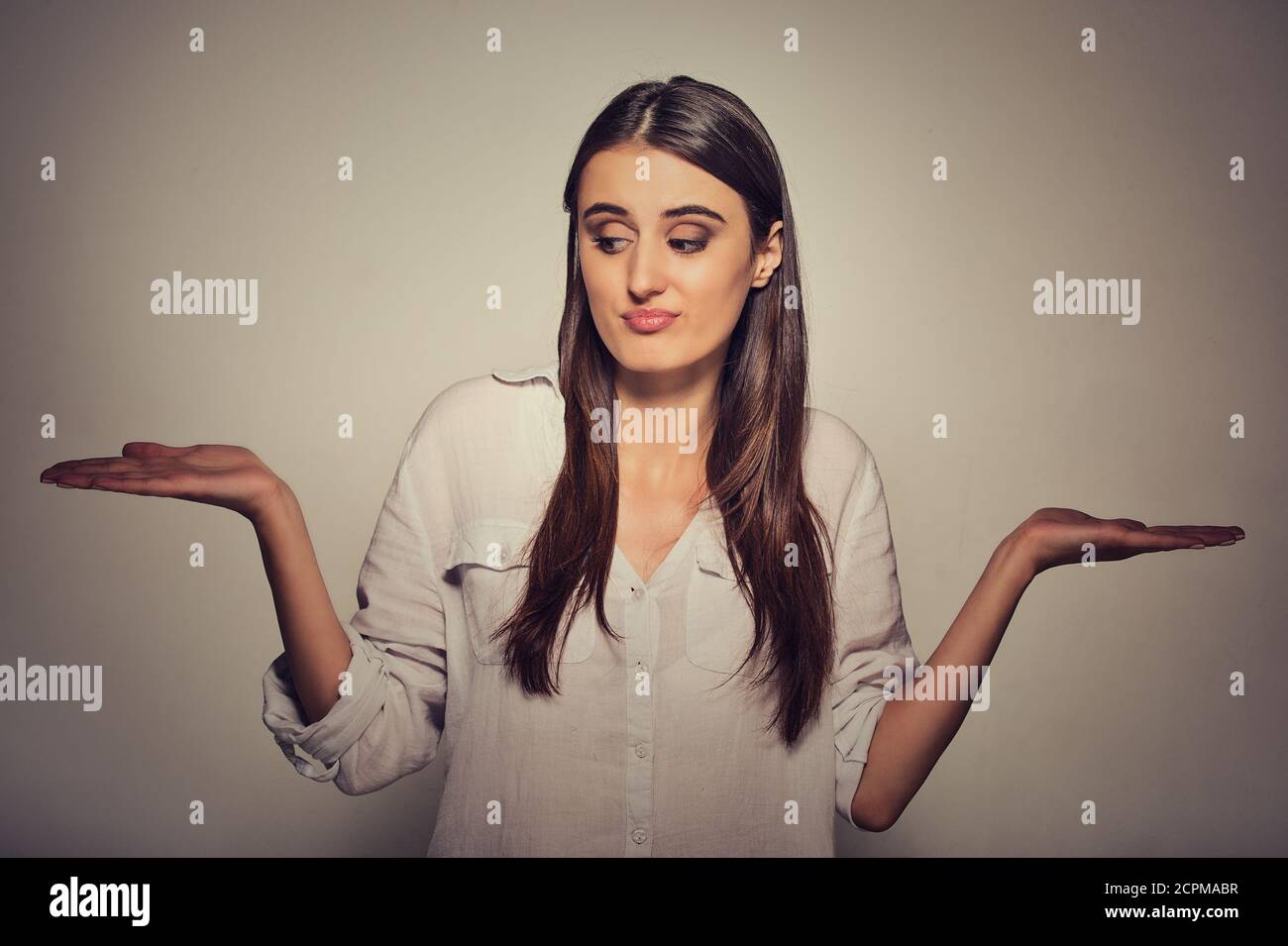 Portrait perplexed looking woman arms out shrugs shoulders I don't know ...