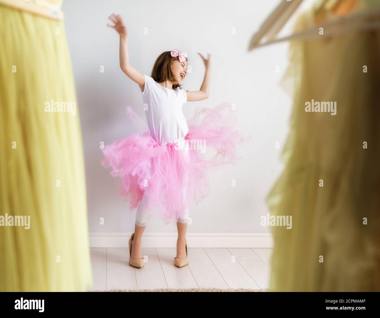 Happy girl dressing up at home. Funny lovely child is having fun in ...