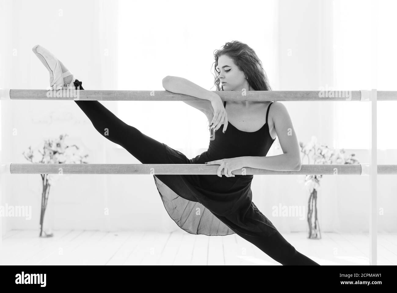 Girl ballerina with curly hair. Black and white photo. BW Stock Photo - Alamy