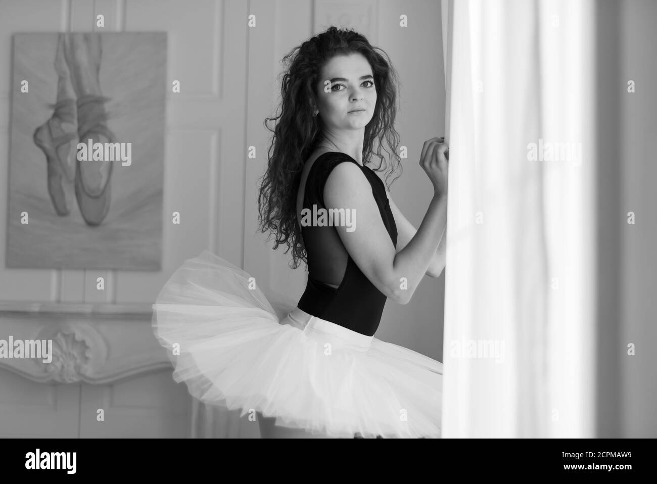 Girl ballerina with curly hair. Black and white photo. BW Stock Photo - Alamy