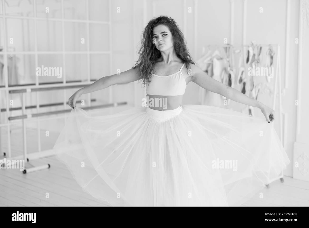Girl ballerina with curly hair. Black and white photo. BW Stock Photo - Alamy