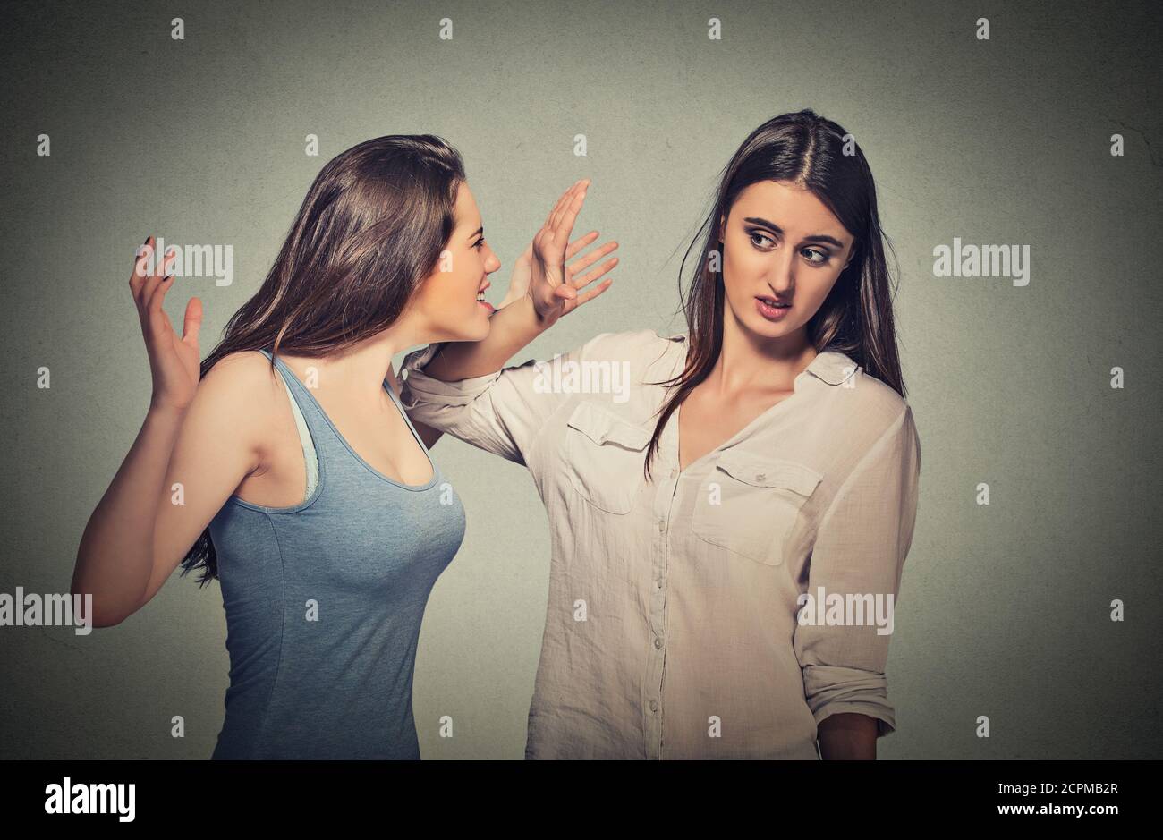 Girl patronizing screaming pointing finger at shy timid nerdy woman who ...