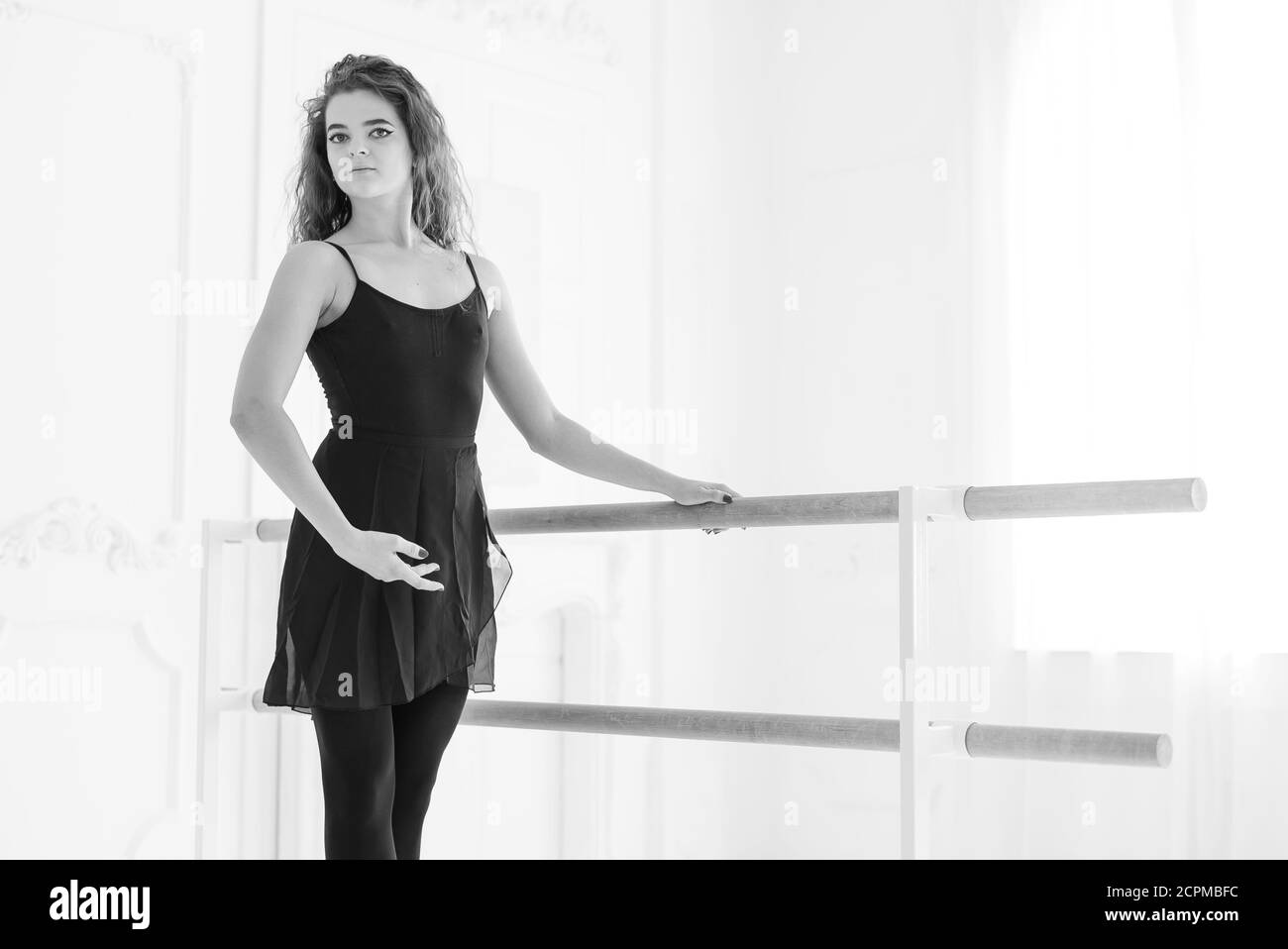 Girl ballerina with curly hair. Black and white photo. BW Stock Photo - Alamy