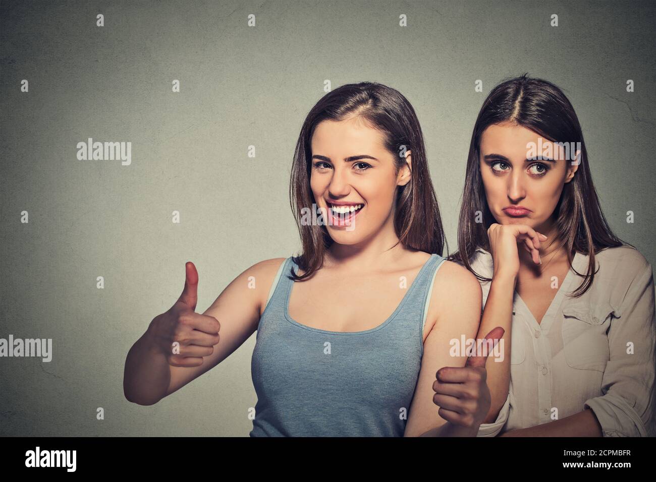 Two women optimistic lady having solution and bored, annoyed clueless ...