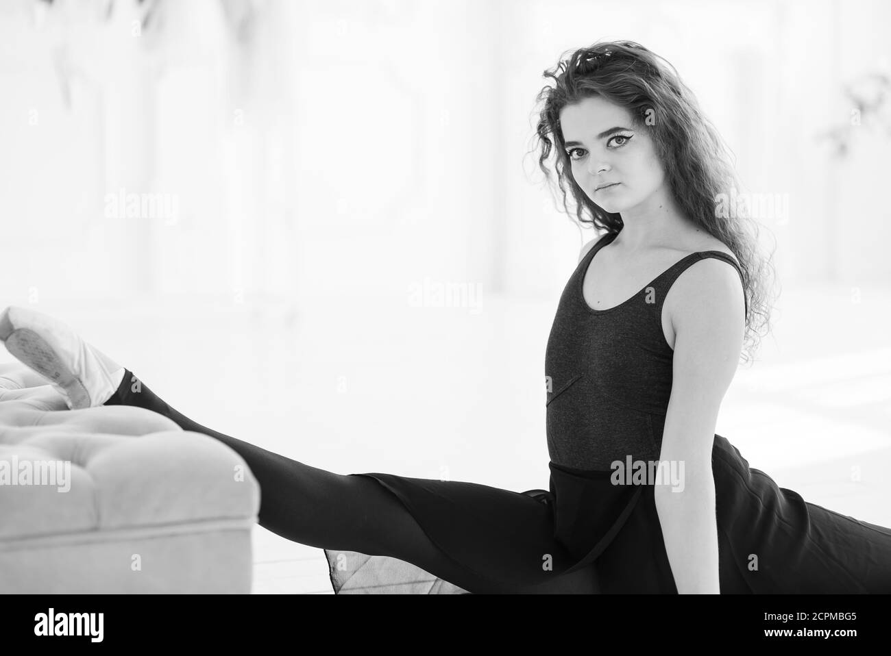 Girl ballerina with curly hair. Black and white photo. BW Stock Photo - Alamy
