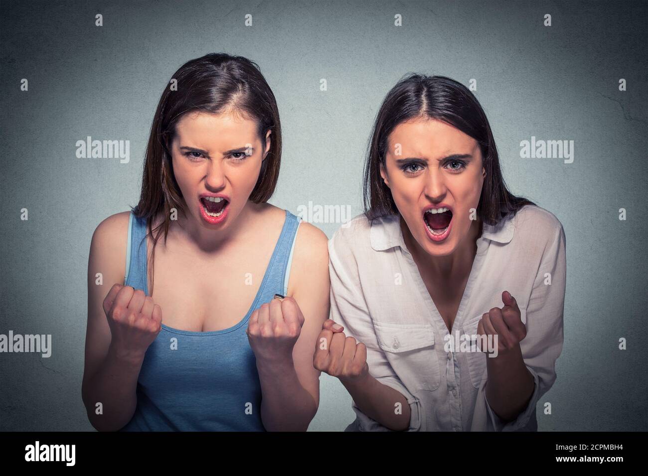 Two beautiful angry women screaming Stock Photo - Alamy