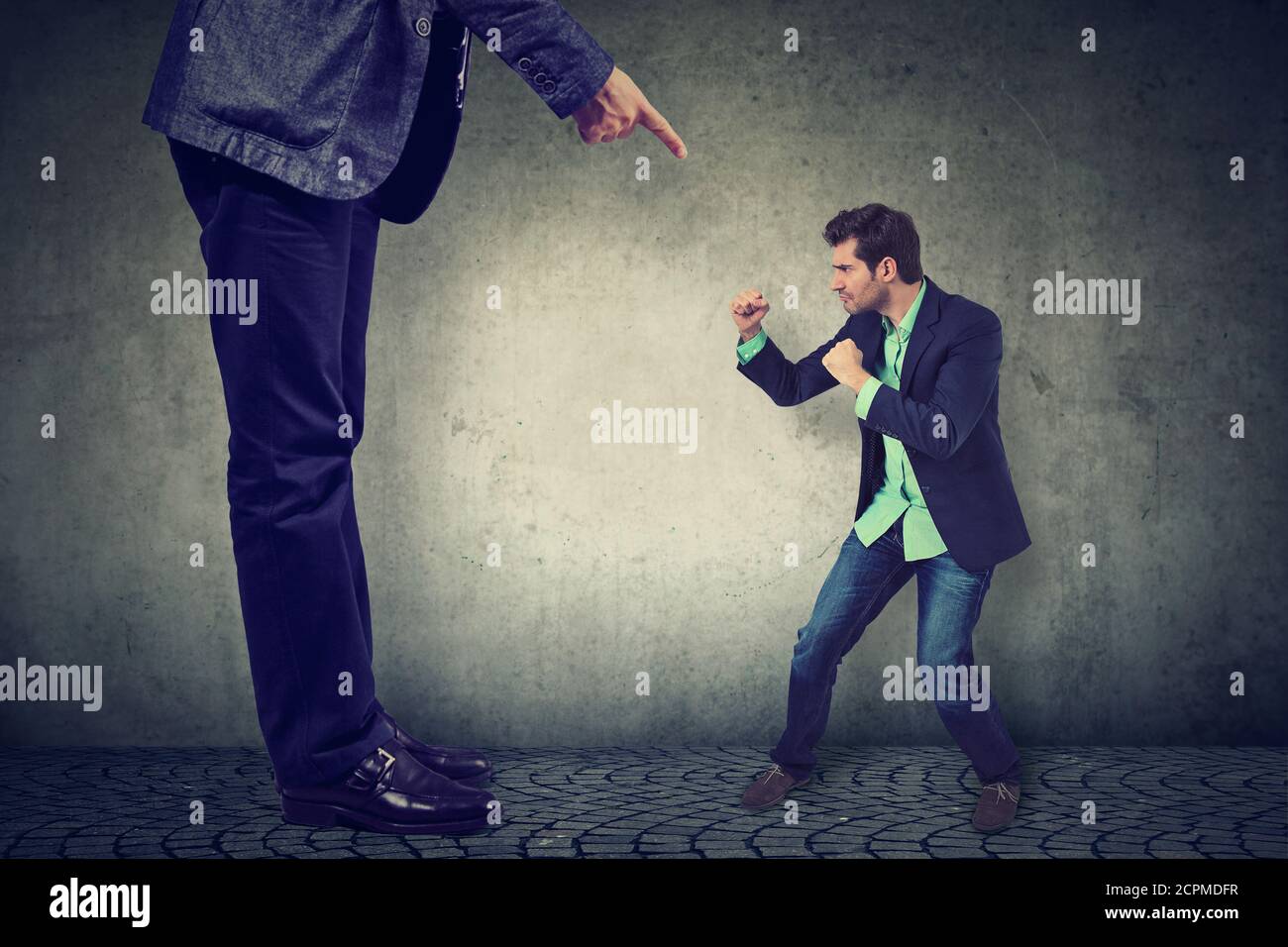 Man fighting against his big boss Stock Photo - Alamy