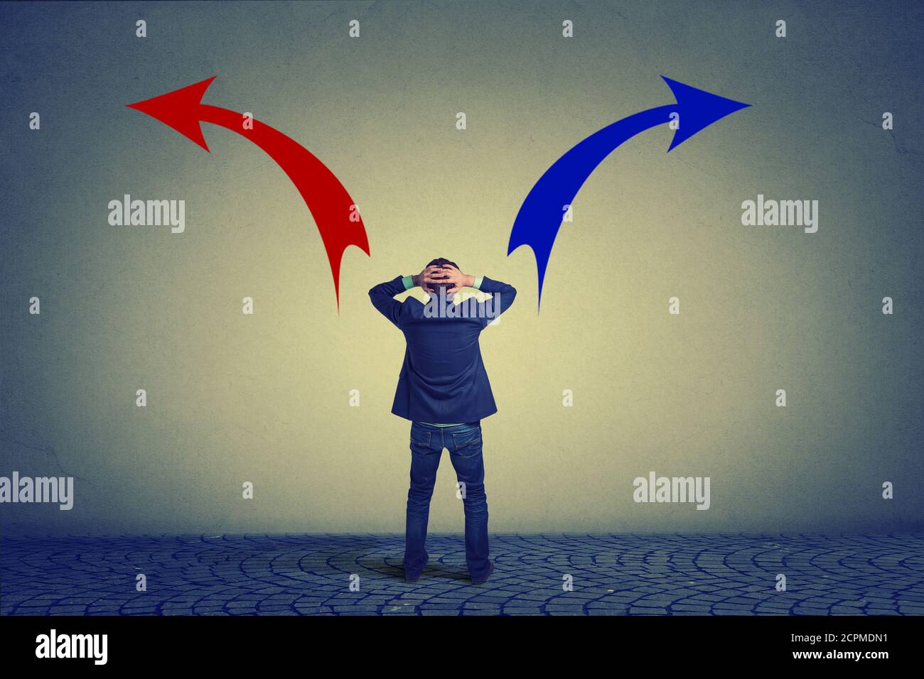 Rear view of business man standing in front of wall hands on head ...