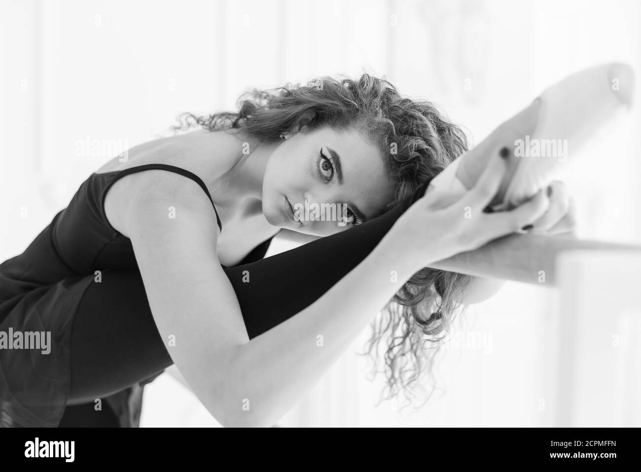 Girl ballerina with curly hair. Black and white photo. BW Stock Photo - Alamy
