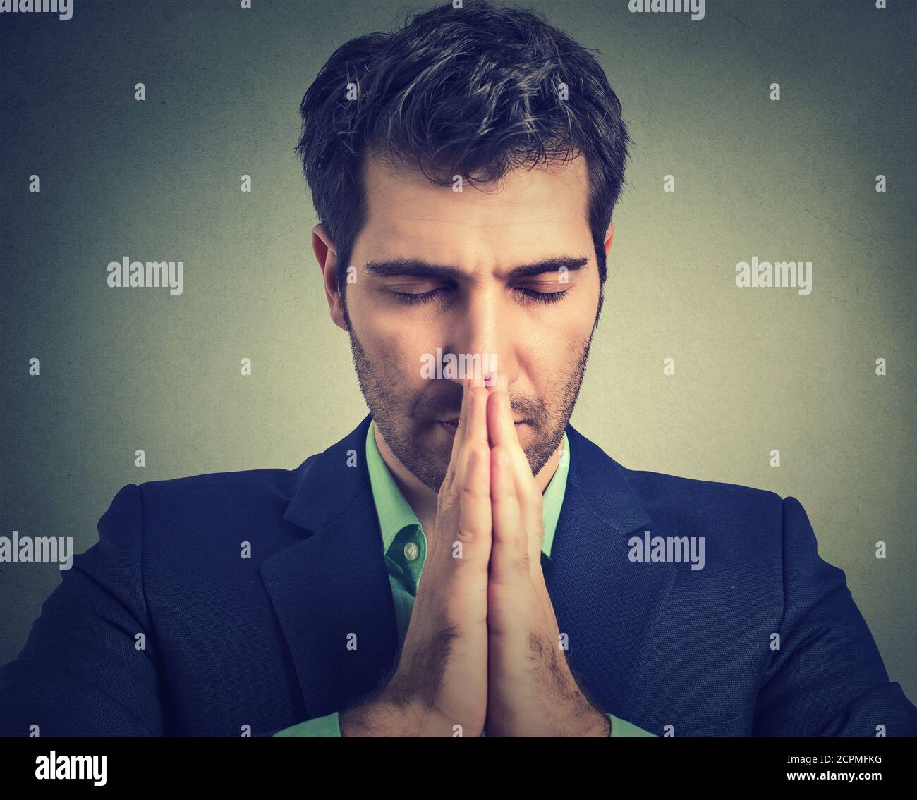 Closeup portrait of young desperate man isolated on gray wall ...