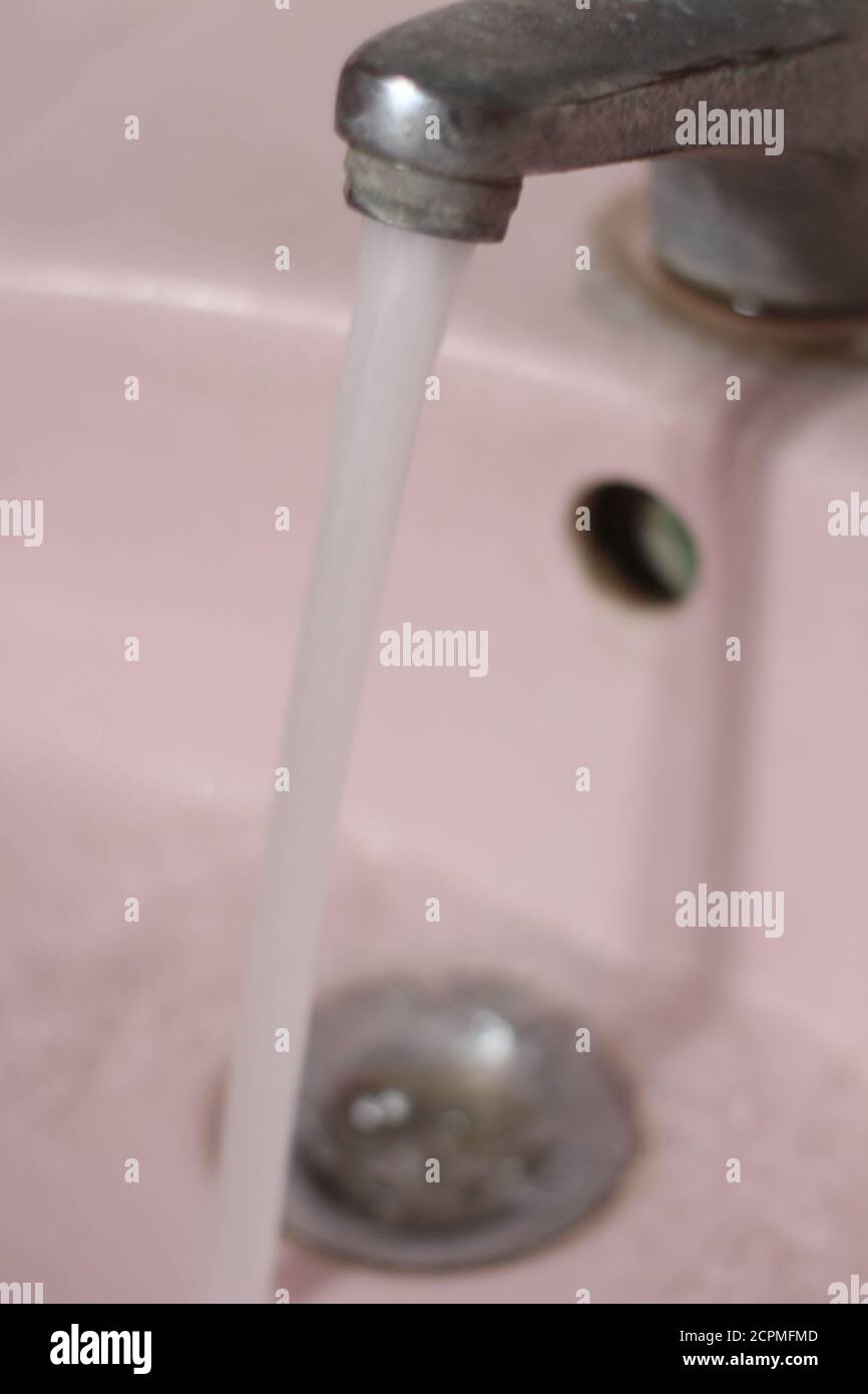 water flowing from faucet in bathroom Stock Photo - Alamy