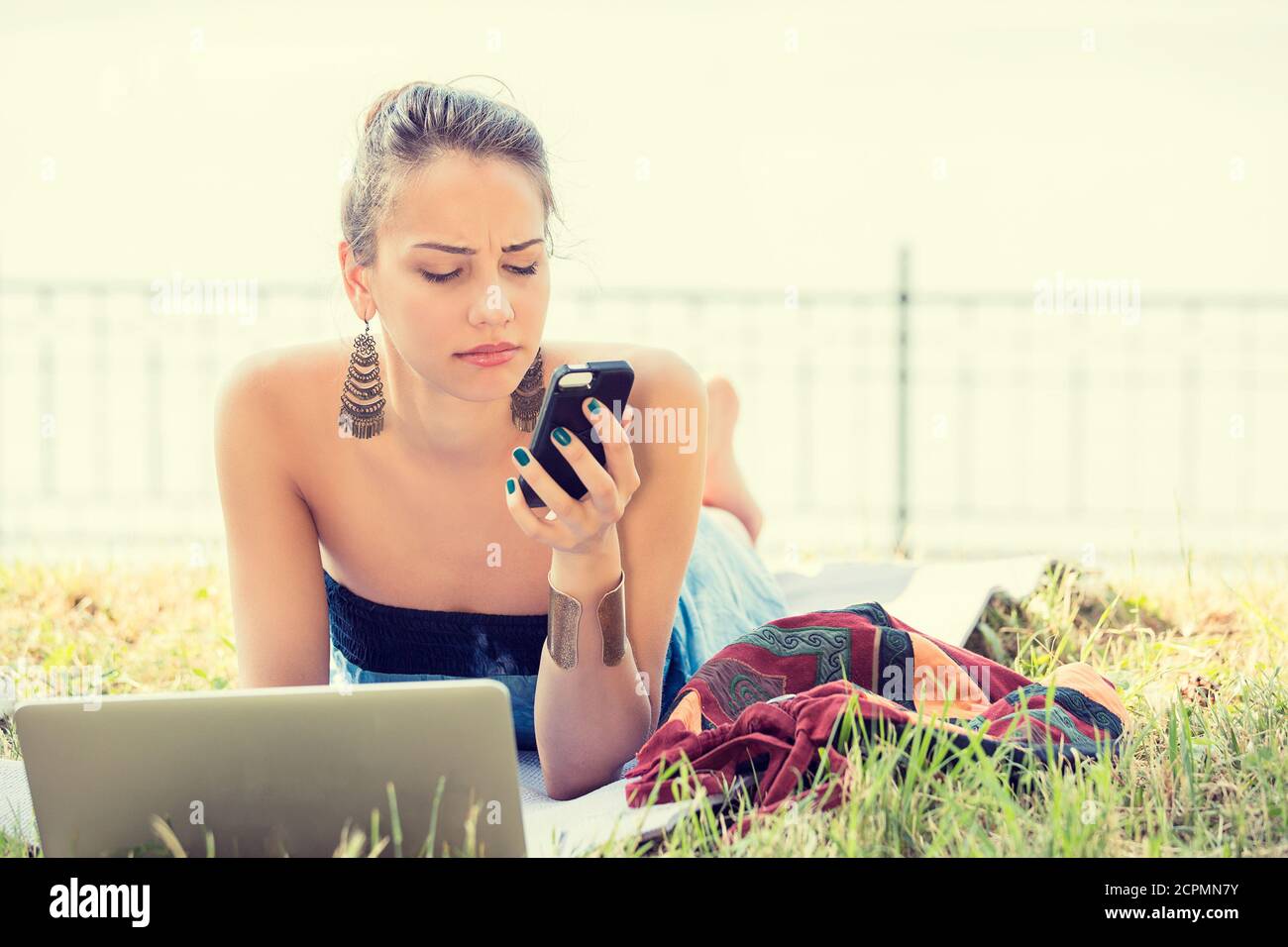 Upset Sad Skeptical Unhappy Serious Woman Texting On Phone Outdoors In