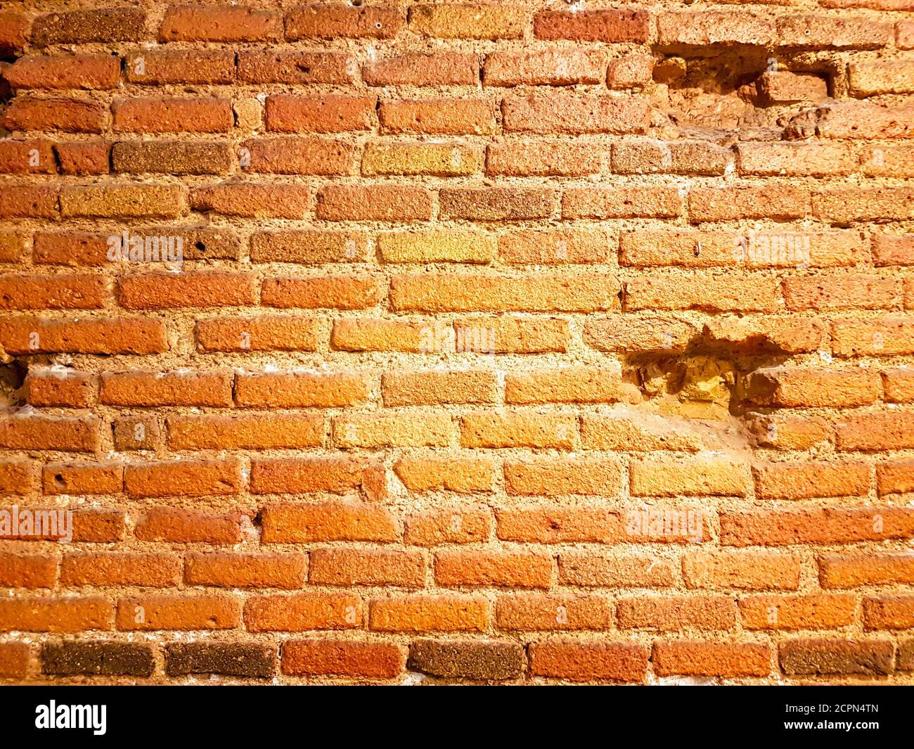 Brick wall background in rural room, grungy rusty blocks of stonework ...