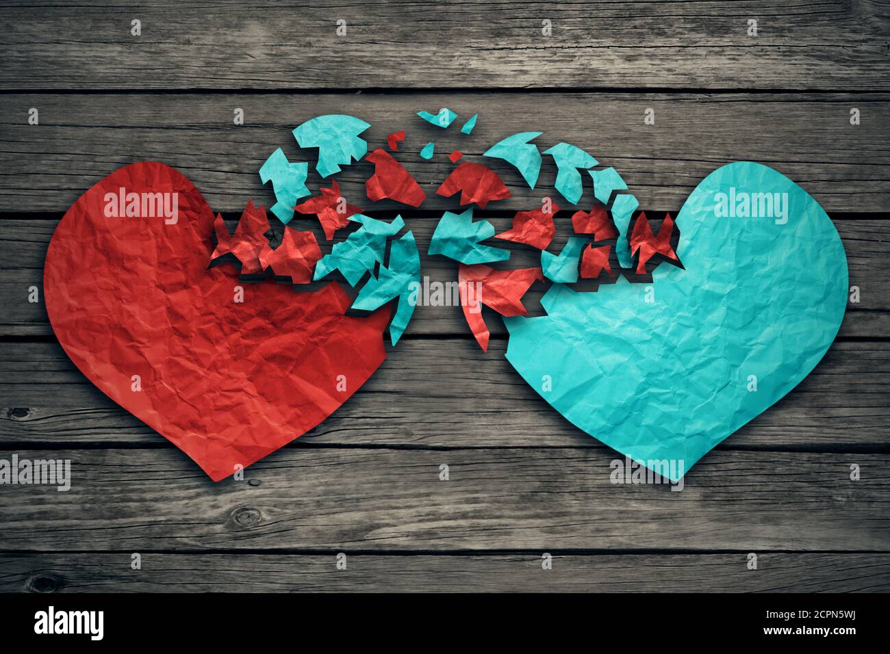 Romantic relationship concept as two hearts made of torn crumpled paper ...