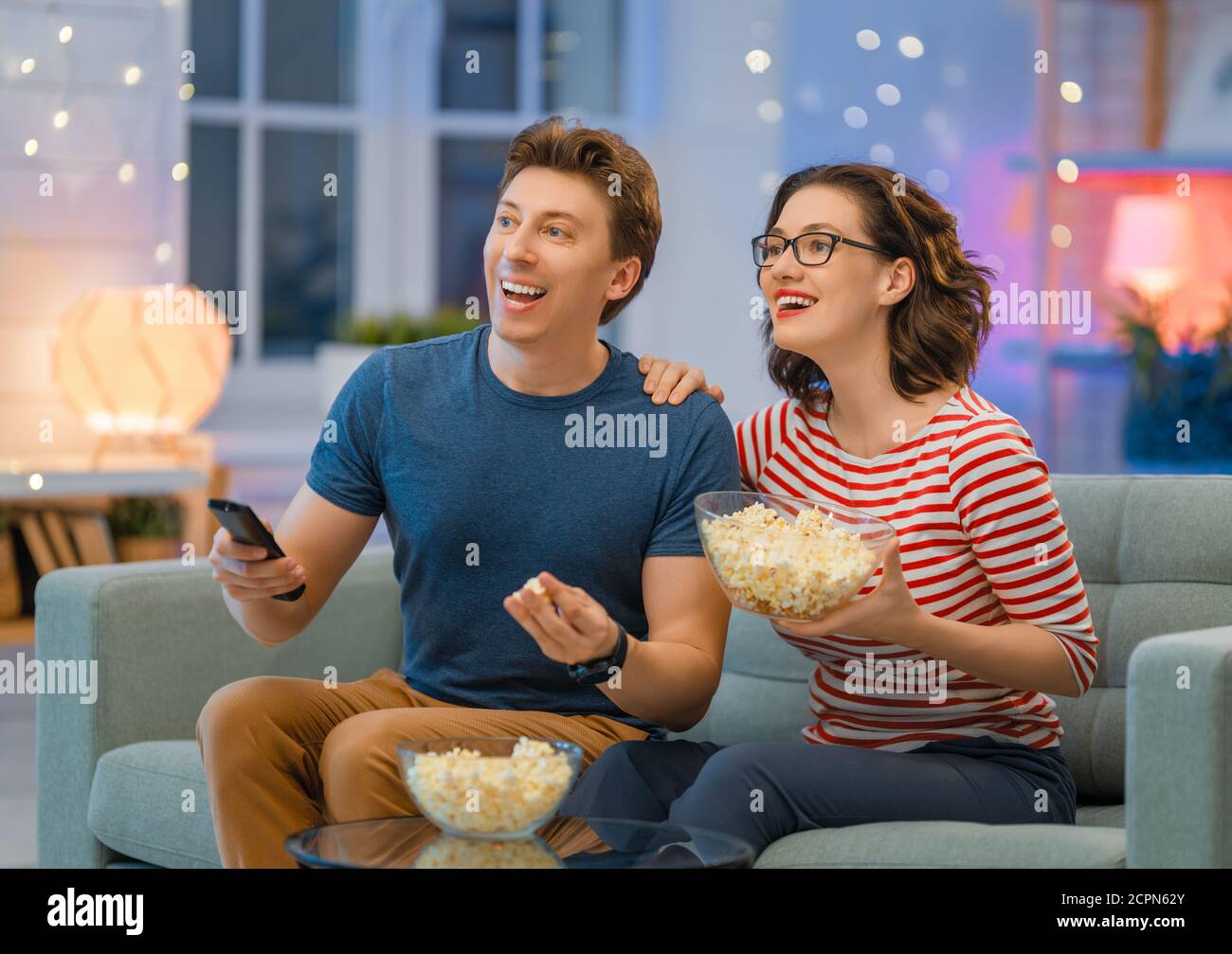 Family watching movie with projector hi-res stock photography and ...