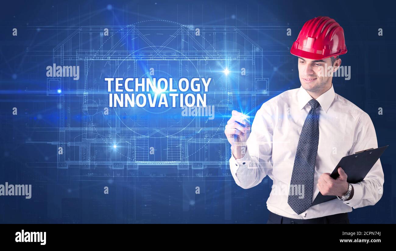 Handsome architect with helmet drawing TECHNOLOGY INNOVATION ...