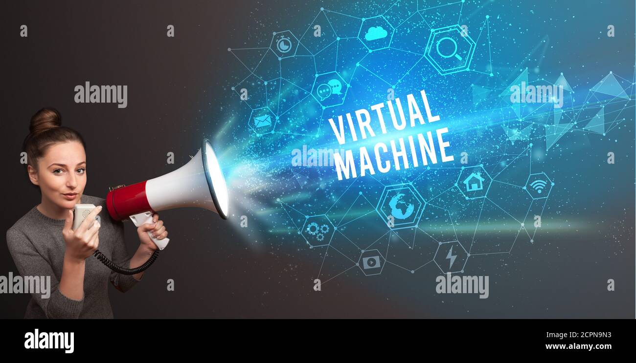 Young woman shouting in megaphone with VIRTUAL MACHINE inscription ...