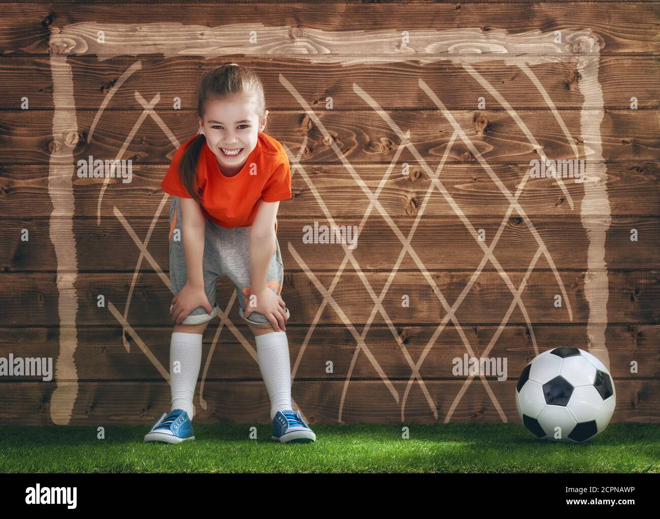 Cute little child dreams of becoming a soccer player. Girl plays ...