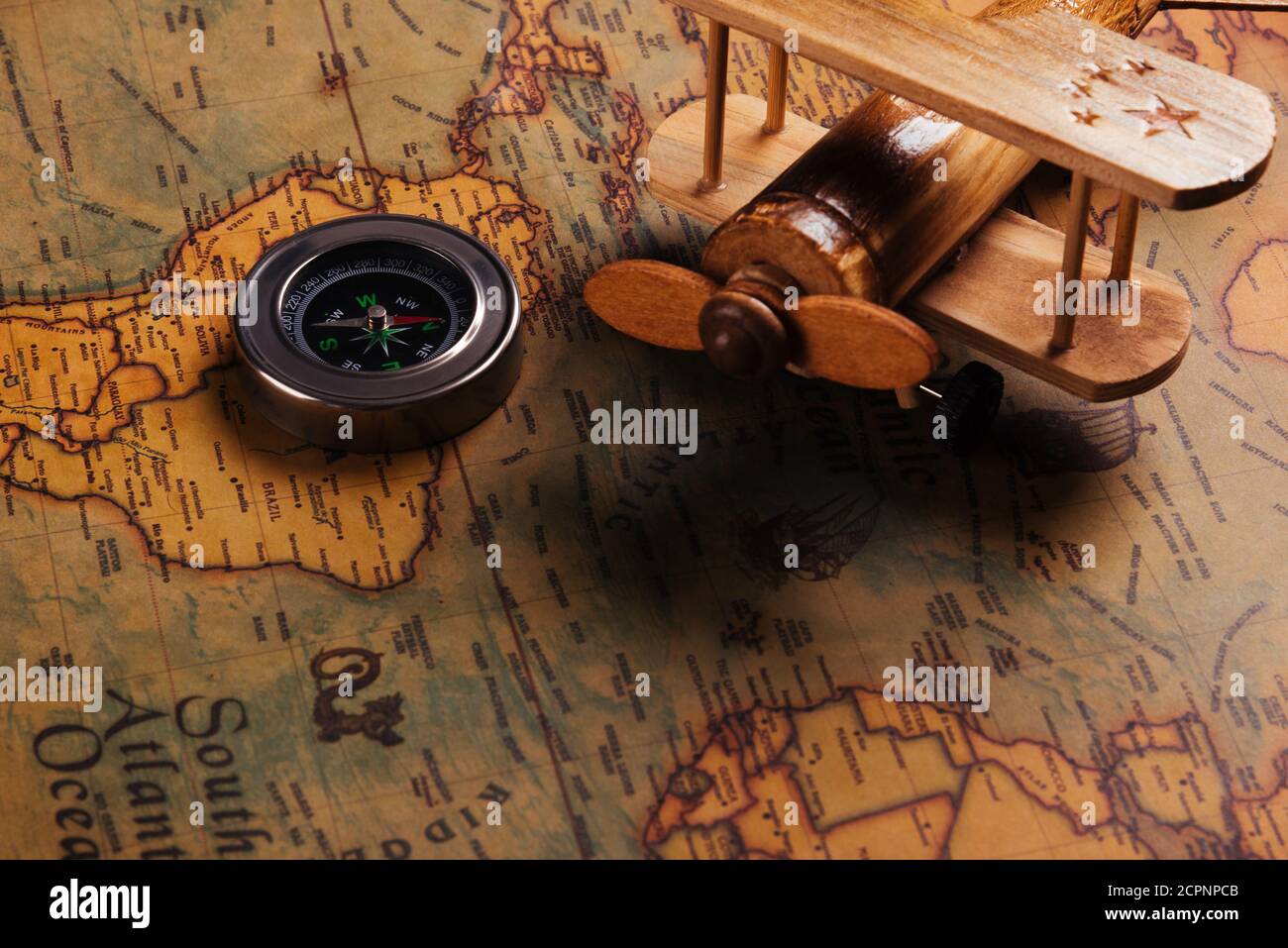 Old compass discovery and wooden plane on vintage paper antique world ...