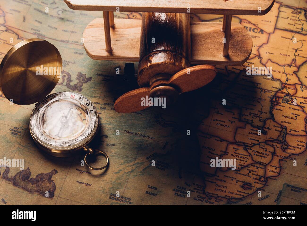 Old compass discovery and wooden plane on vintage paper antique world ...