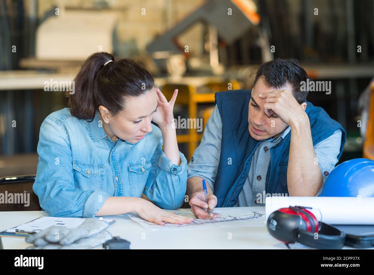 industrial worker and client studying a possible design Stock Photo - Alamy