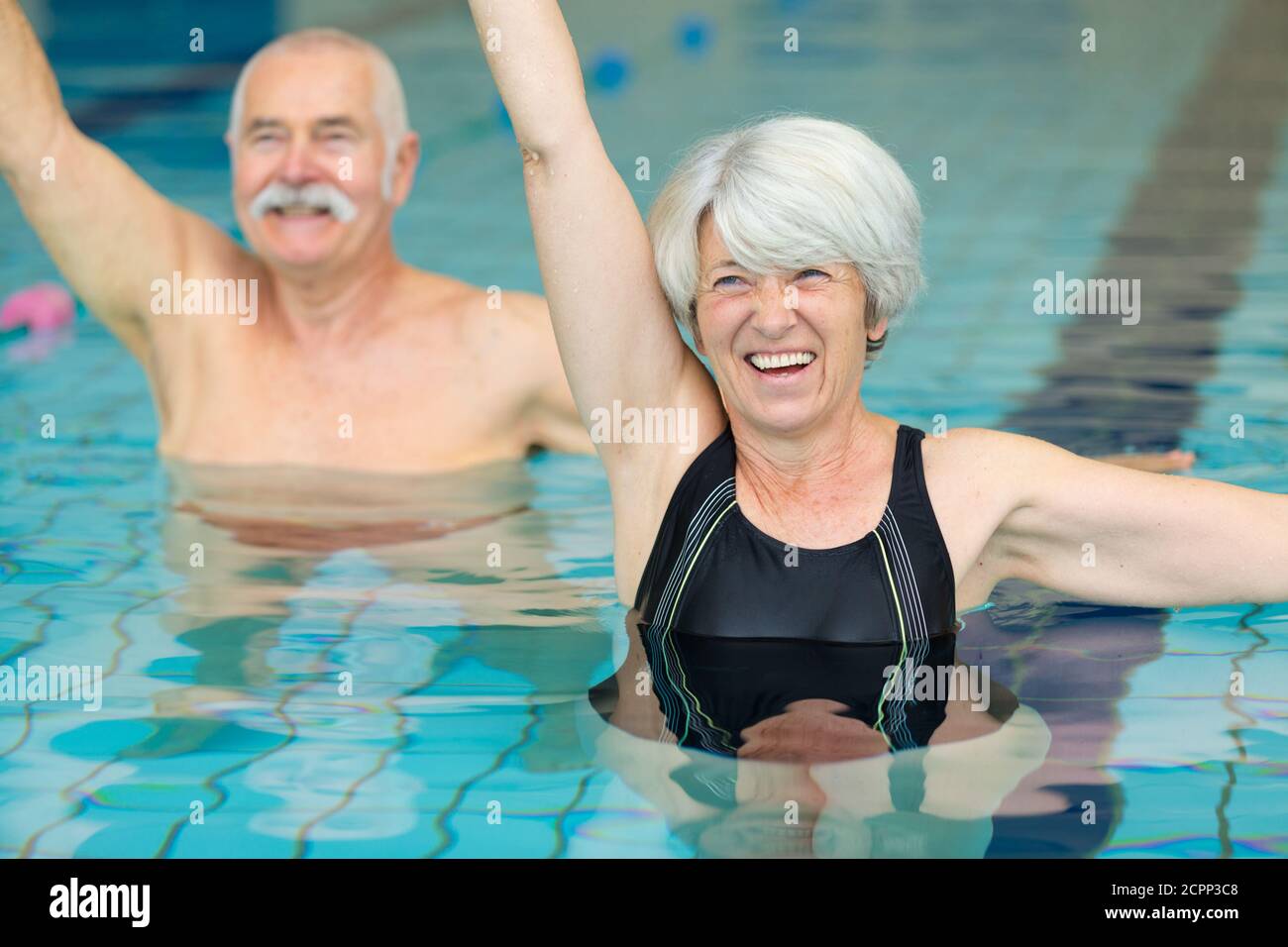 happy senior couple dancing in the pool Stock Photo - Alamy