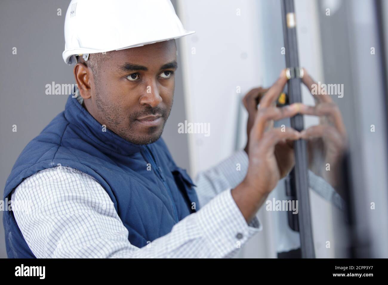 male window fitter adjusting glass Stock Photo - Alamy