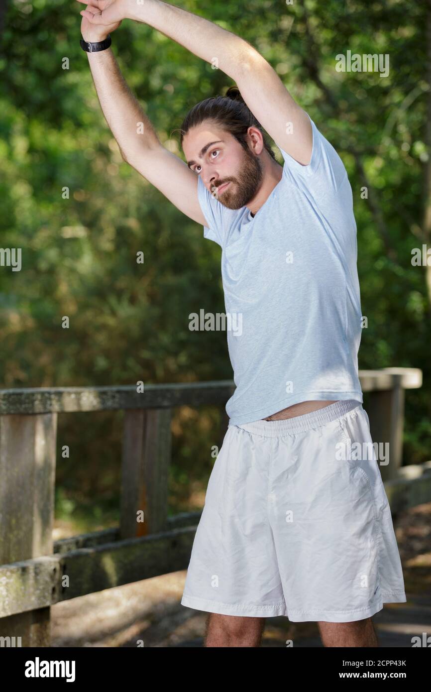 Casual man stretching sunset hi-res stock photography and images - Alamy