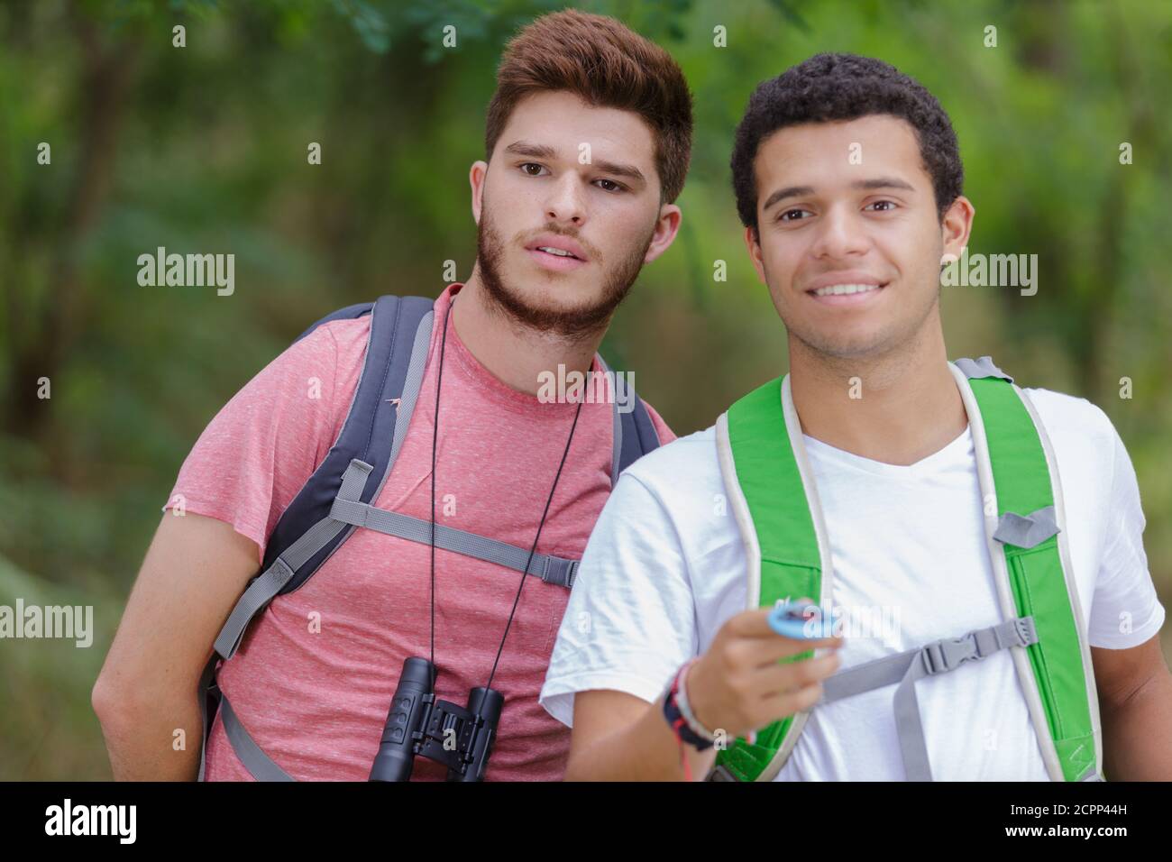 two young tourist determine the route map and compass Stock Photo - Alamy